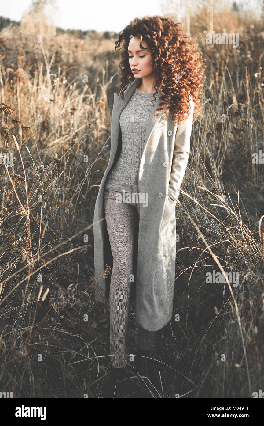 Outdoor fashion photo of young beautiful lady in autumn landscape with ...