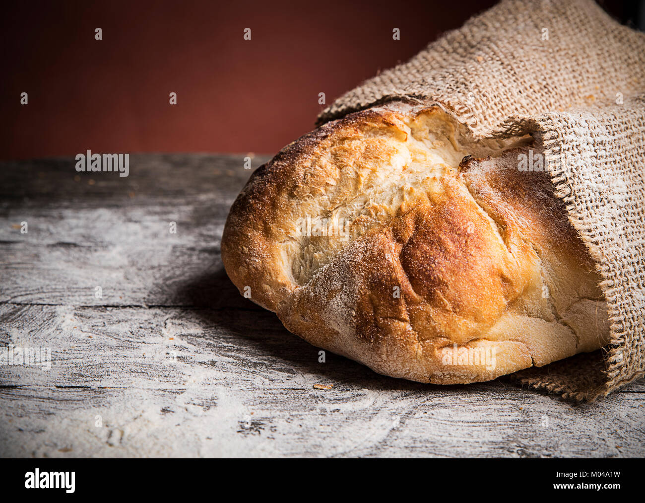 Rustic bread loaf on dark background Stock Photo - Alamy