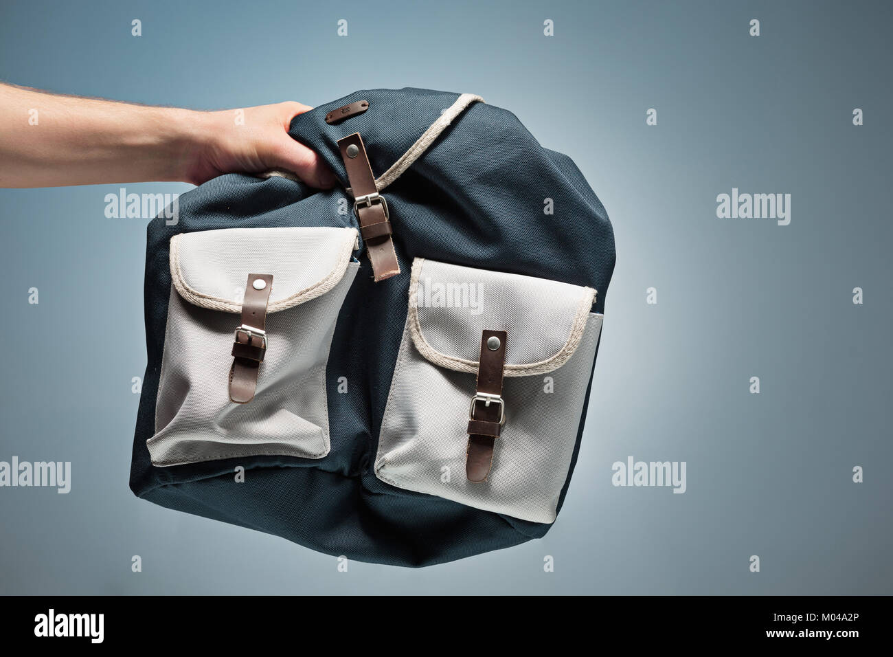The male hand holding his backpack Stock Photo - Alamy