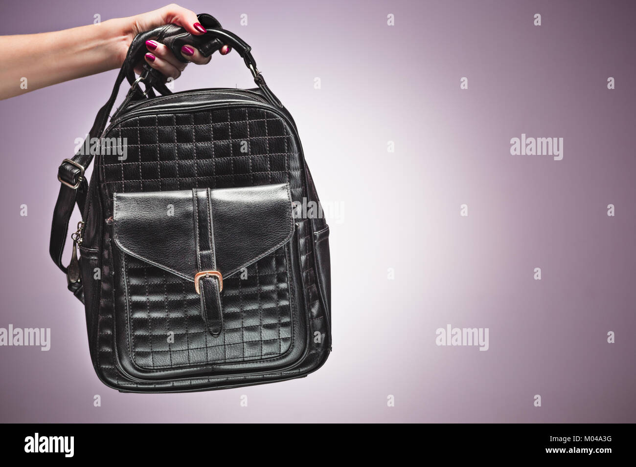 Woman hand holding backpack Stock Photo - Alamy