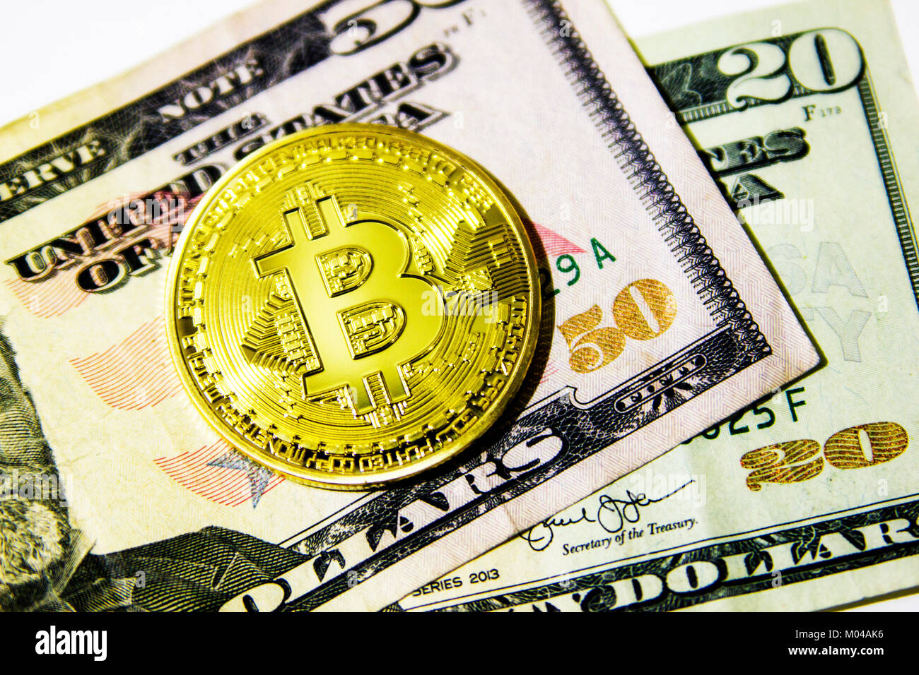Bitcoin on top of notes, US Dollars Stock Photo - Alamy