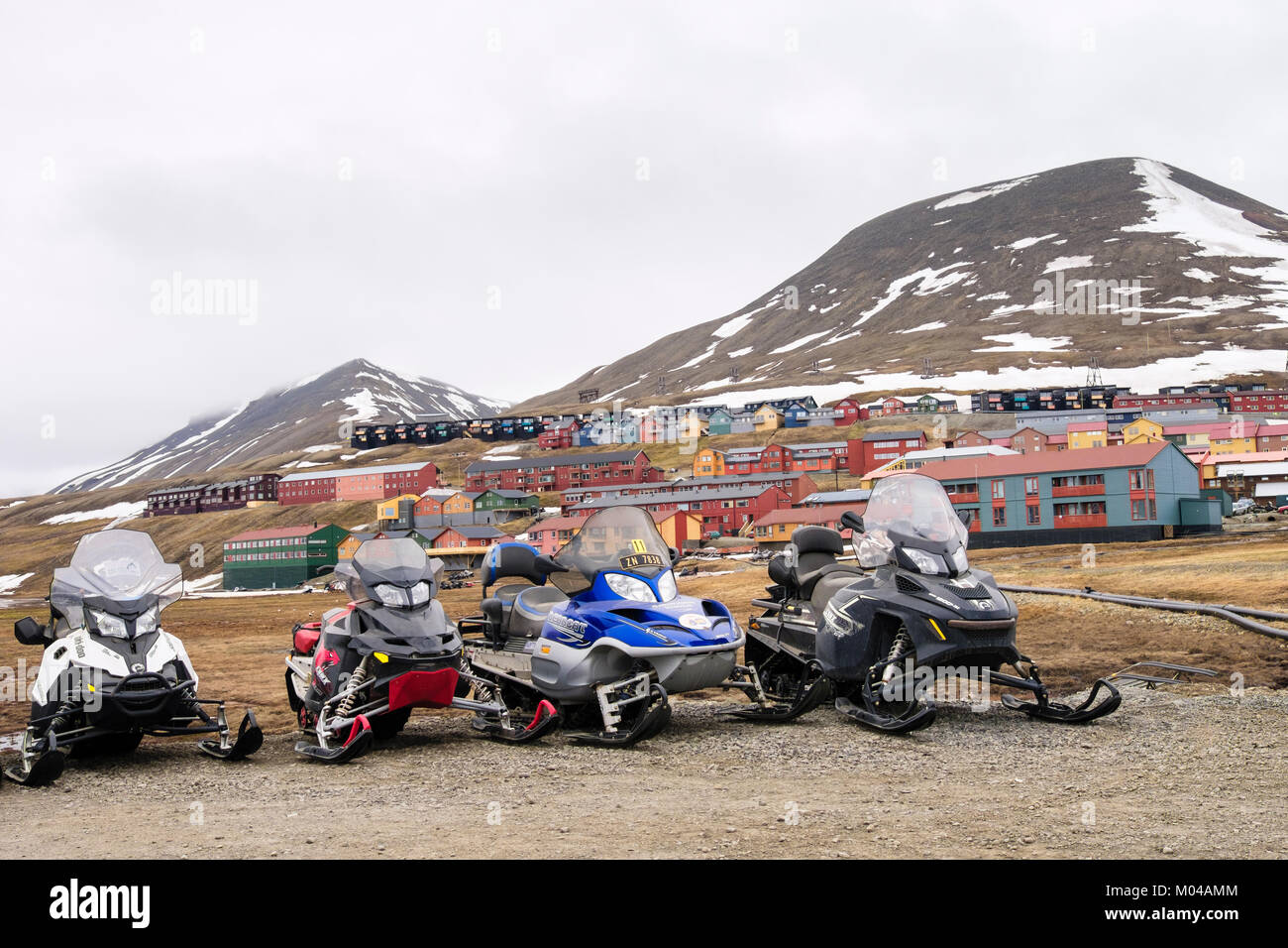 Motorised snowmobile scooters parked on roadside in summer in old ...