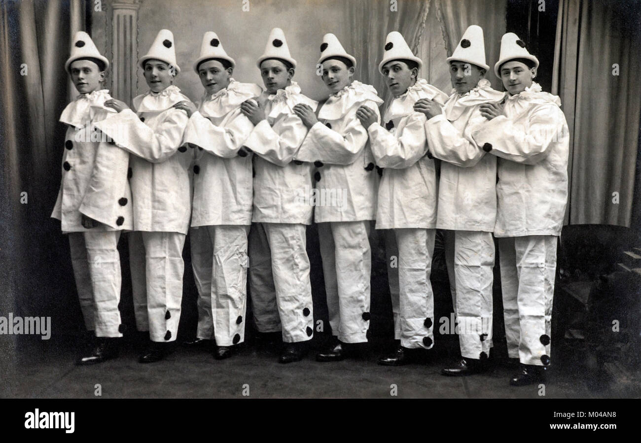 8 clowns circa 1910 lined up on stage, vintage photograph Stock Photo ...