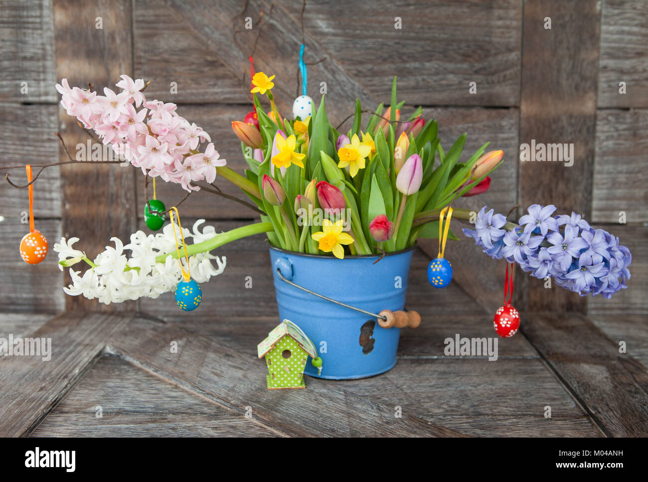 Colorful spring flowers in vintage blue bucket Stock Photo - Alamy