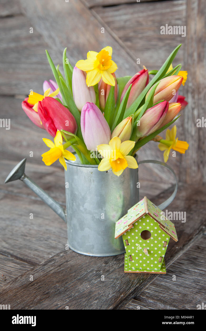 Colorful spring flowers on a rustic wooden background Stock Photo - Alamy