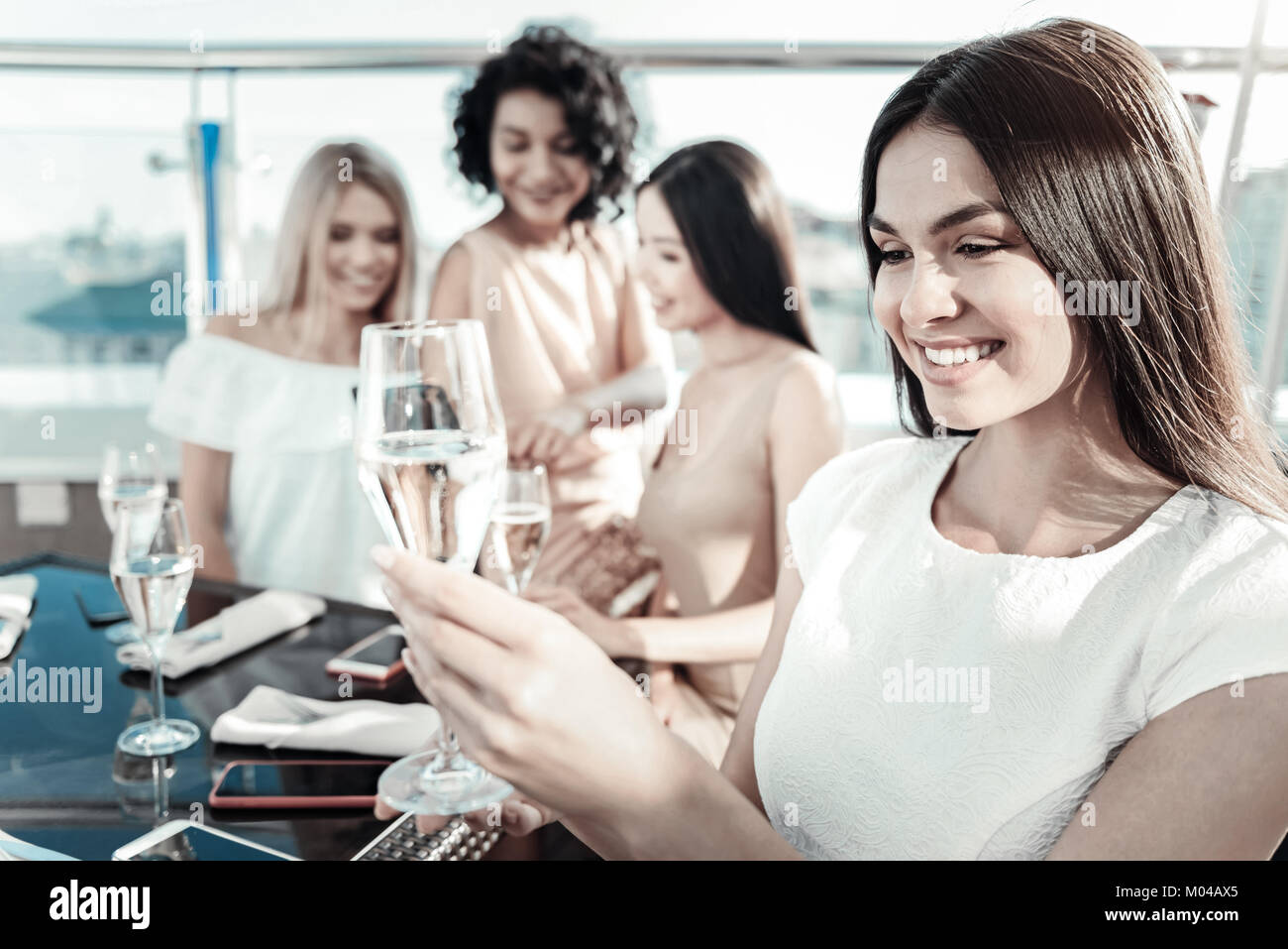 Pleasant cute girl keeping goblet and overlooking it Stock Photo - Alamy
