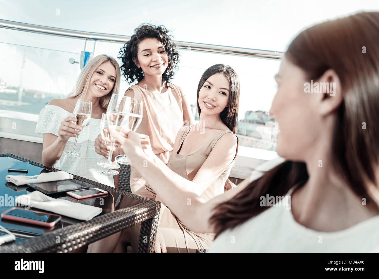 Young beautiful girls having rest and drinking champagne Stock Photo ...