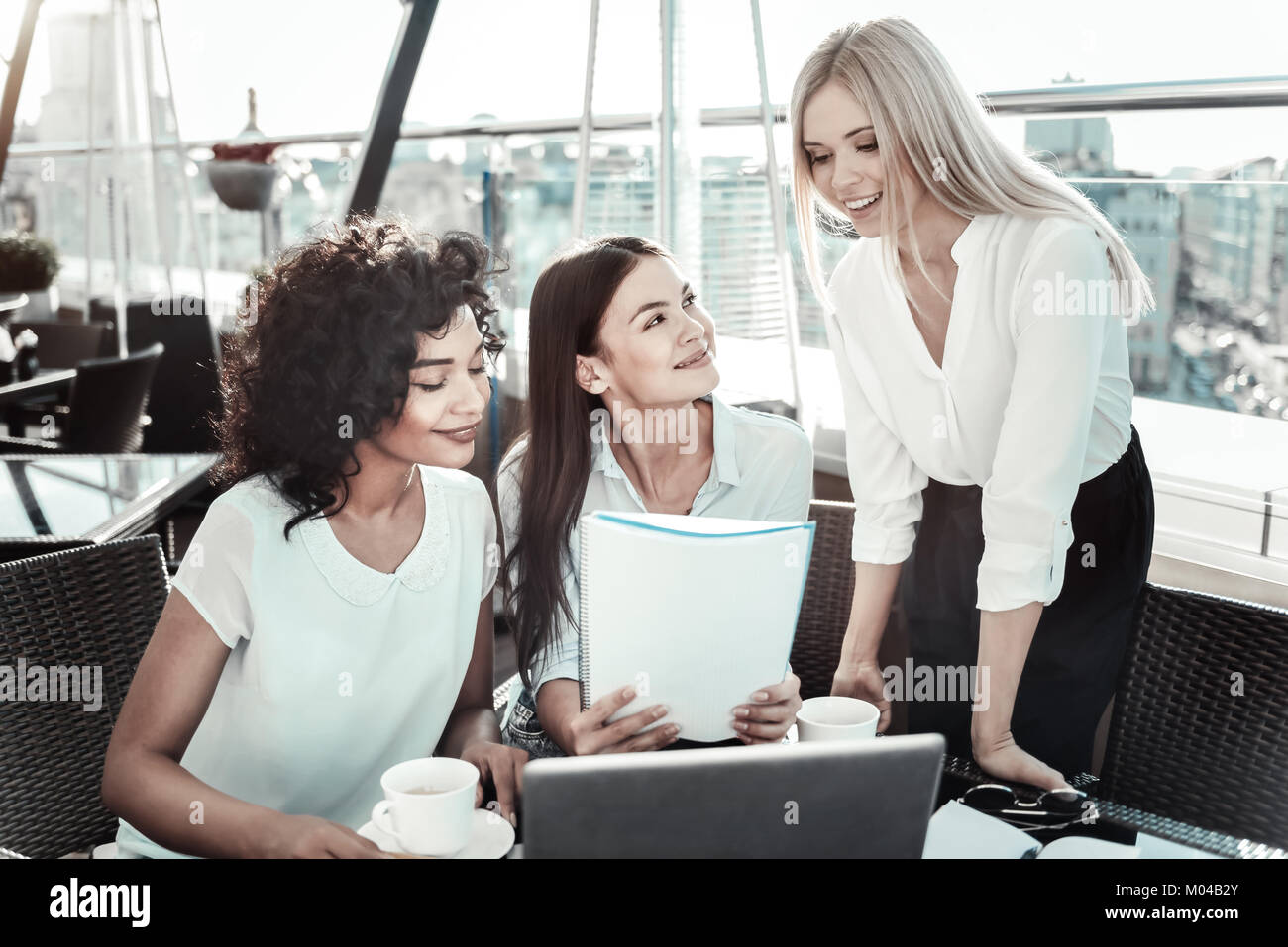 Cute joyful girls working together and having fun Stock Photo - Alamy