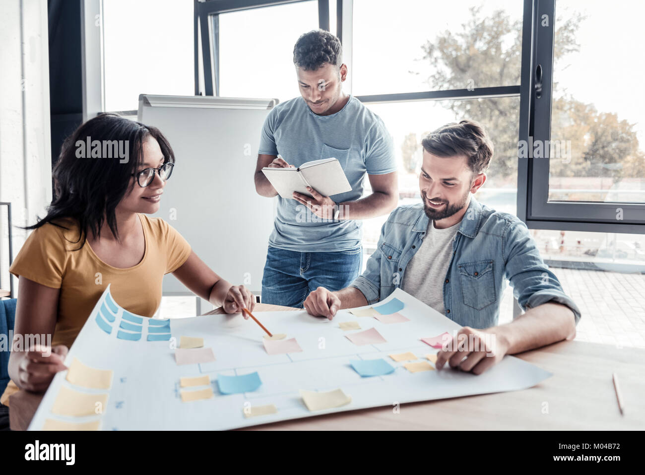 International students discussing home assignment at college Stock ...