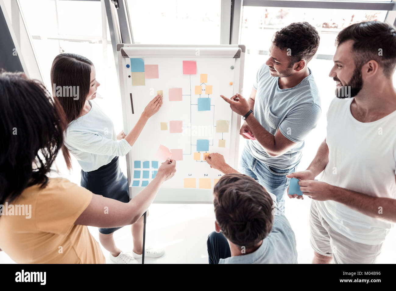 Smiling entrepreneurs working on project together Stock Photo - Alamy