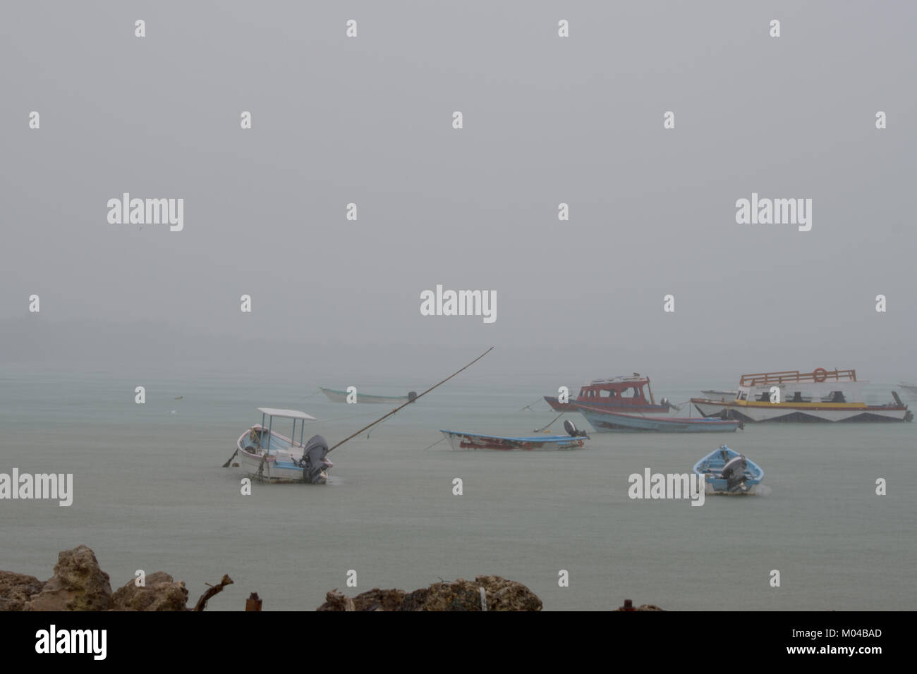 Fishing boats in rainy weather Stock Photo - Alamy