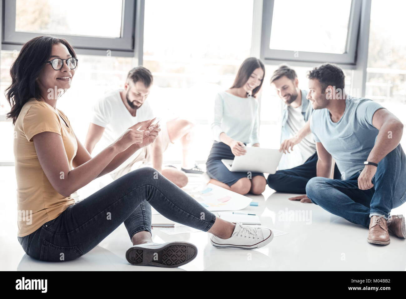 Smiling female student using transparent smartphone Stock Photo - Alamy