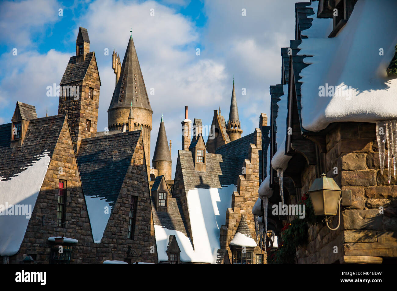 Medieval village rooftops adorned with snow, bathed in the morning sun ...