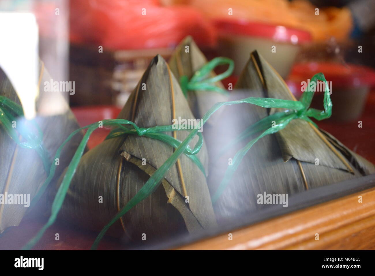 rice dumpling wrapped in pandan leaves Stock Photo - Alamy