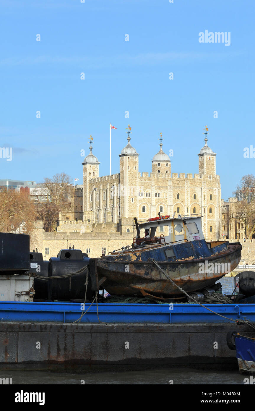 an unusual or different view across the river thames of the tower of ...