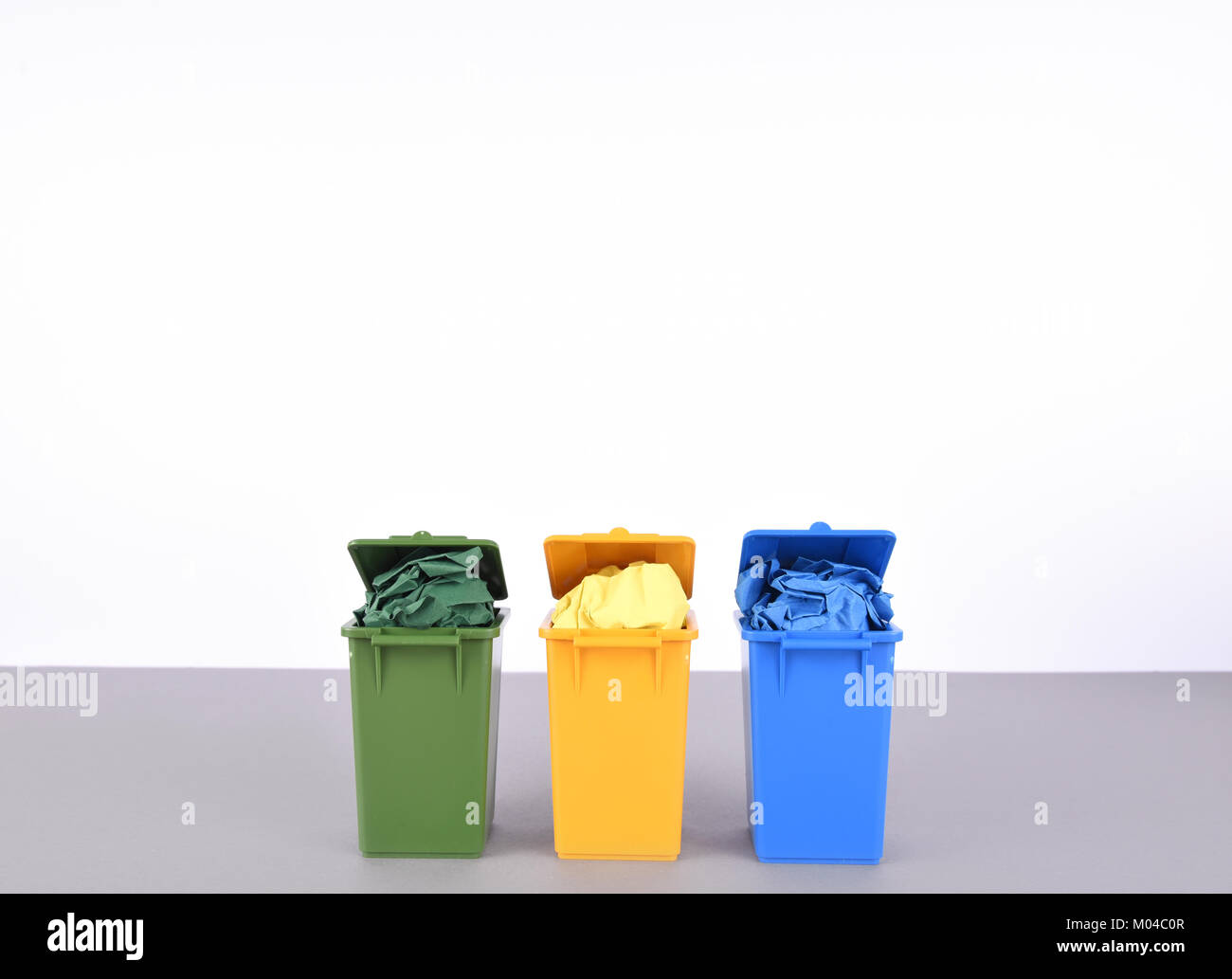 Colorful recycle bins on white background Stock Photo - Alamy