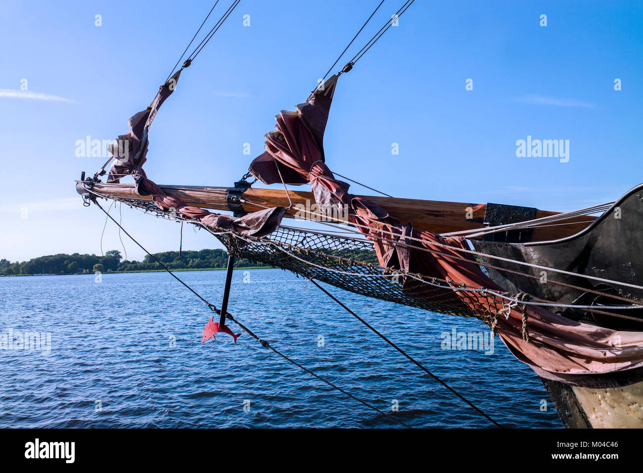 Anchor and bow sails on wooden sailing boat Stock Photo - Alamy
