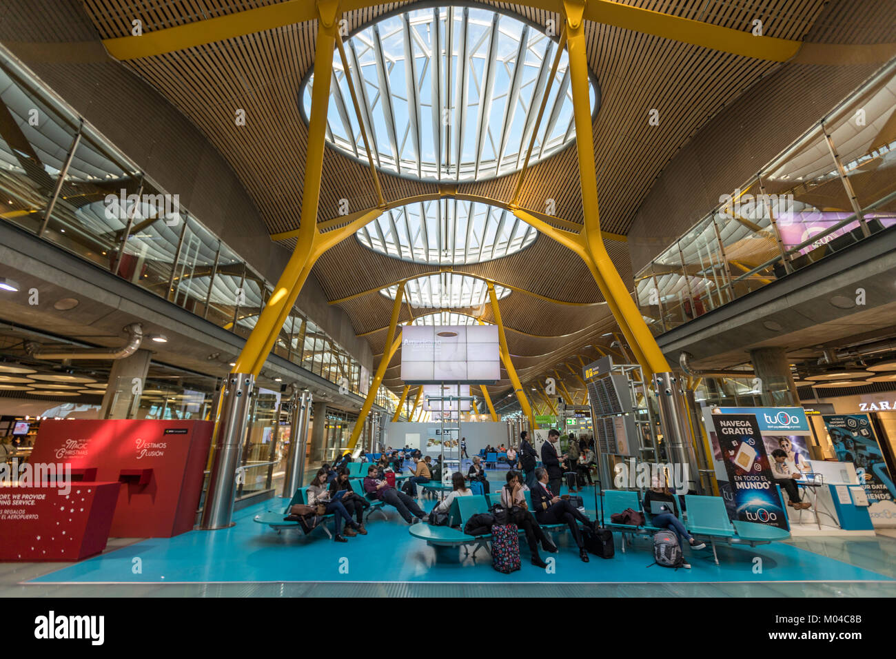 Passengers waiting in the hall of Adolfo Suárez Madrid–Barajas Airport ...
