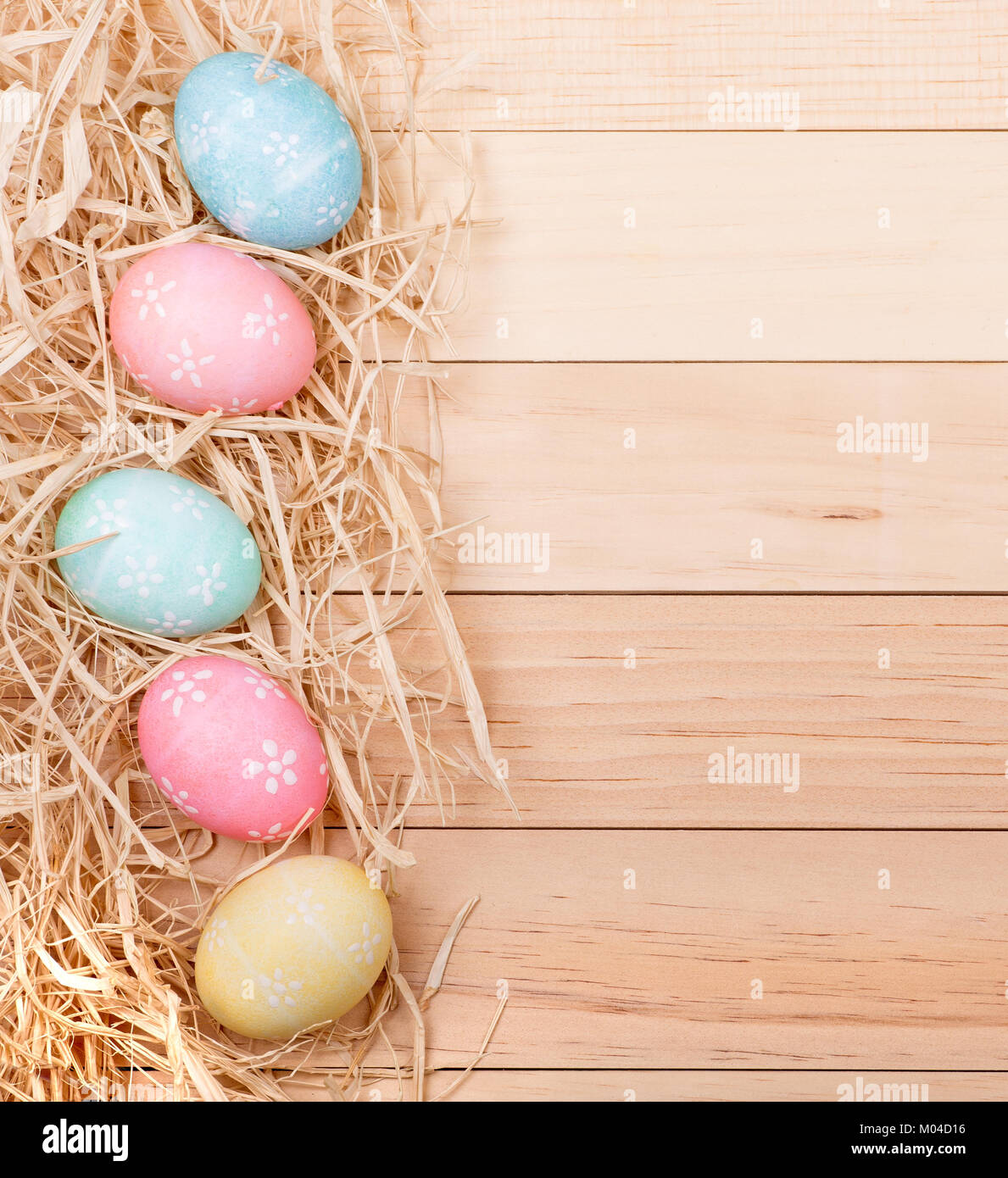 Vertical Easter egg border on a wood background Stock Photo - Alamy