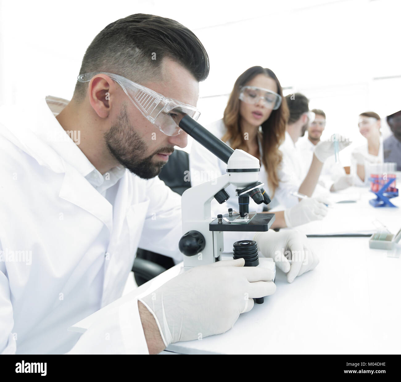 researcher looking into a microscope in a modern laboratory Stock Photo ...