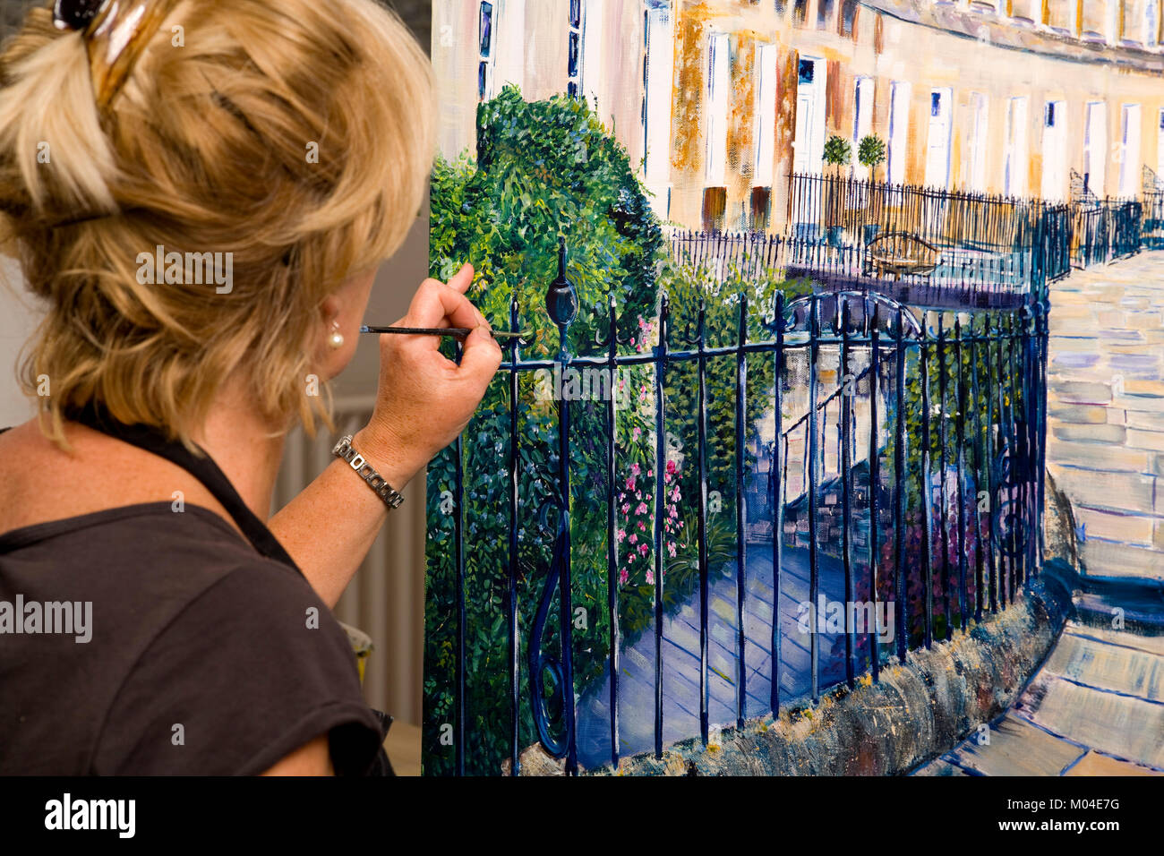 Lady artist at work painting a large acrylic artwork Stock Photo - Alamy