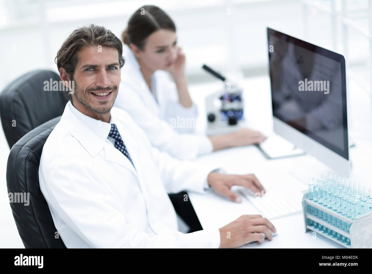Young male technician working on computer in laboratory Stock Photo - Alamy