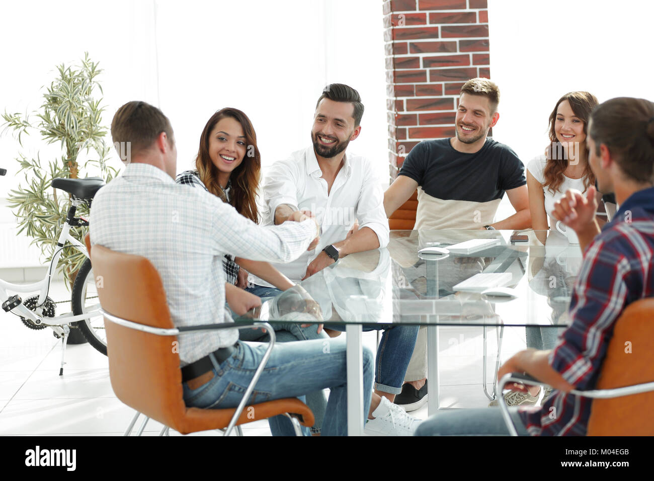 handshake of business partners sitting at the table Stock Photo - Alamy