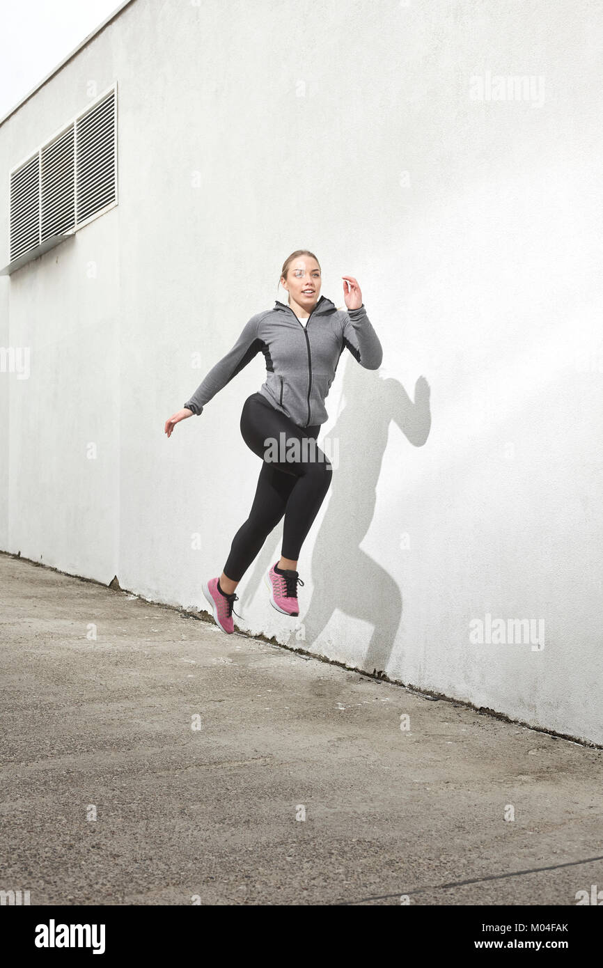 Young woman jumping in air hi-res stock photography and images - Alamy