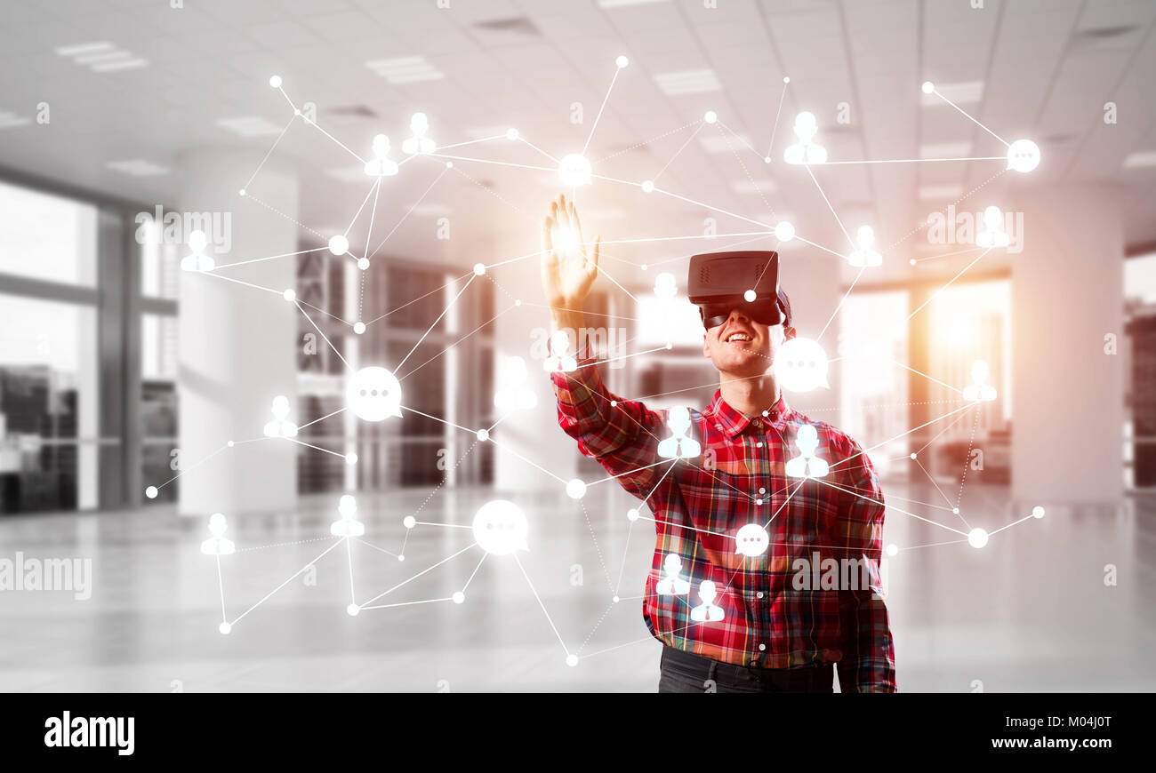 Guy wearing checked shirt and virtual mask reaching hand to touch ...