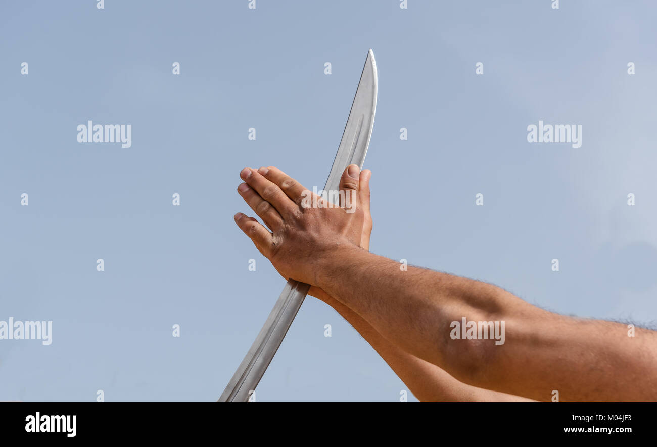 Man stops sword with two hands on the air Stock Photo - Alamy