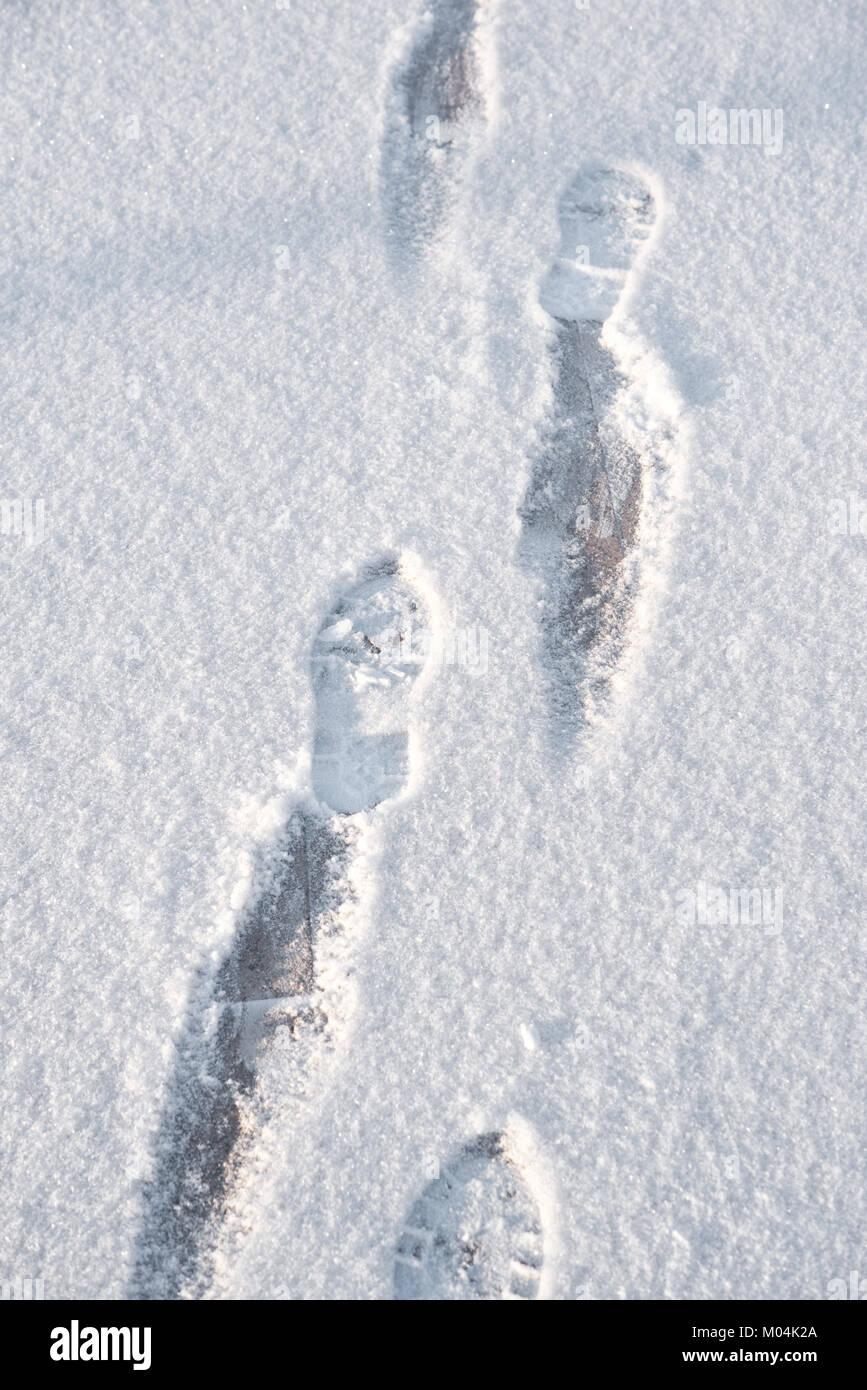Footprints in the fresh snow Stock Photo - Alamy