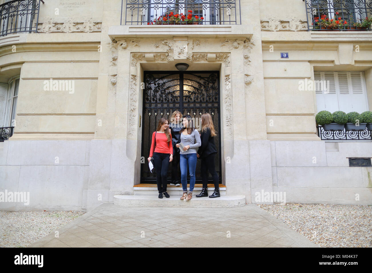 Happy students leaving university building in Stock Photo - Alamy