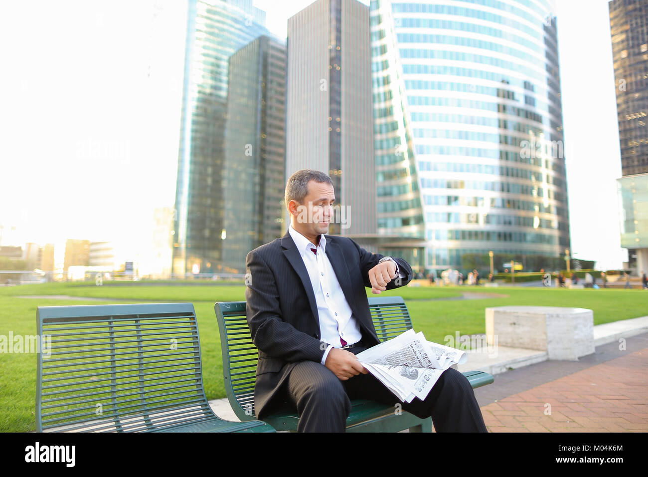 Gladden male manager reading newspaper outside in Stock Photo - Alamy
