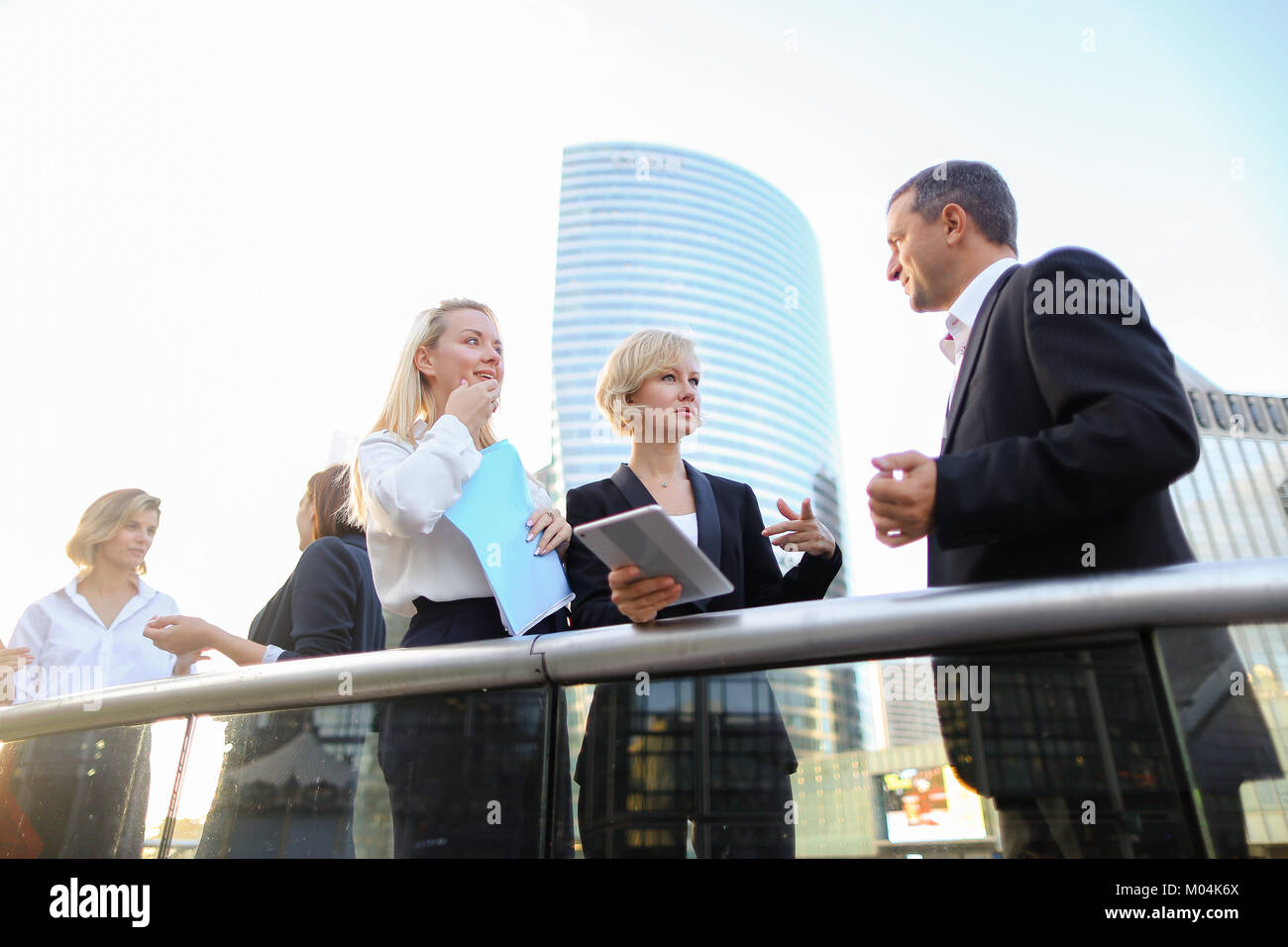 Happy business team members talking outside in Stock Photo - Alamy