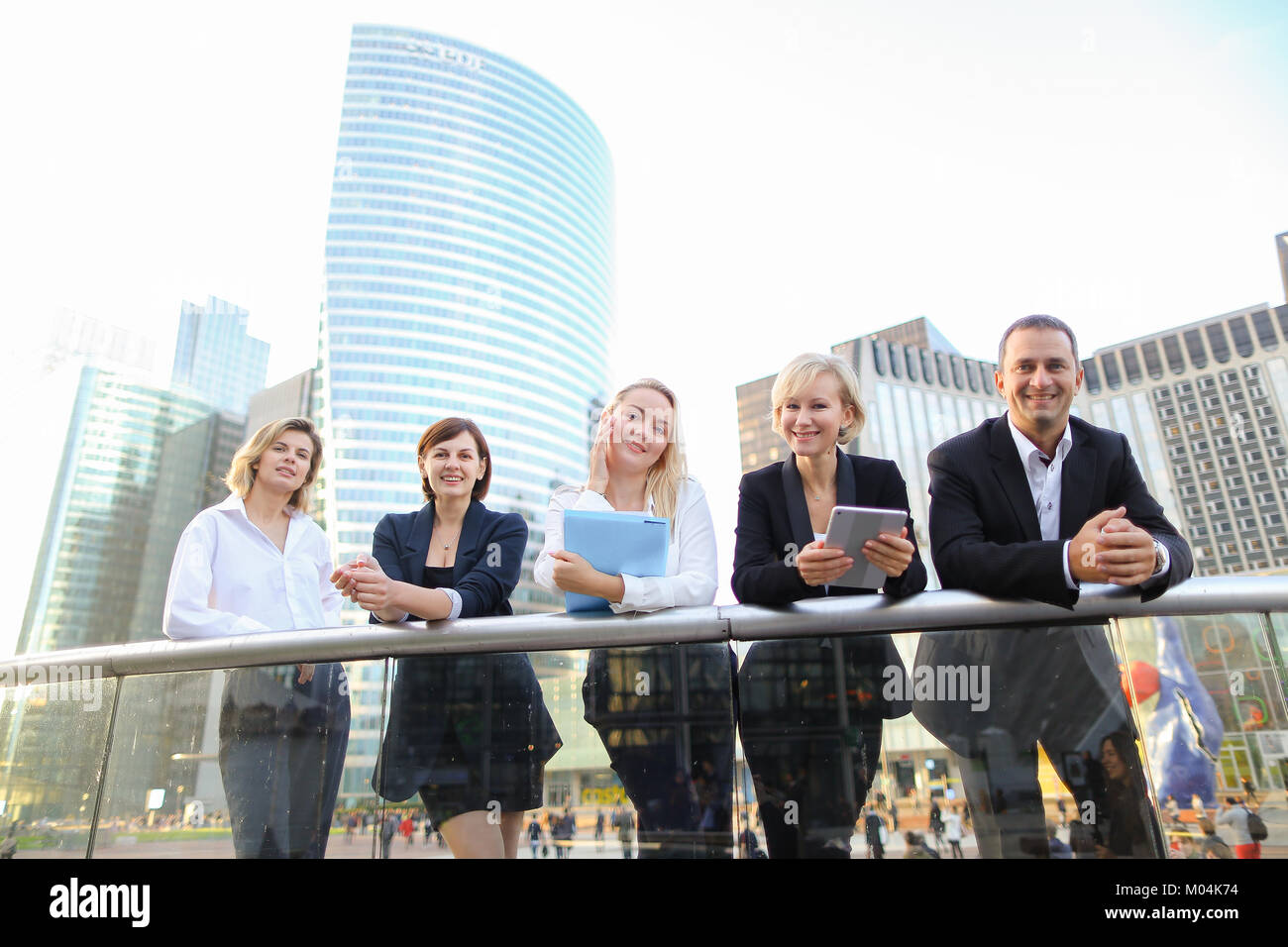 Close up faces financial team looking at camera keeping document Stock ...