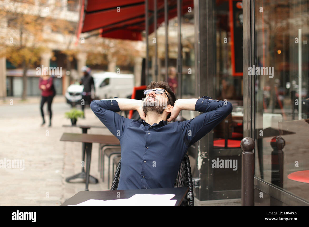 Happy man sitting at cafe table Stock Photo - Alamy