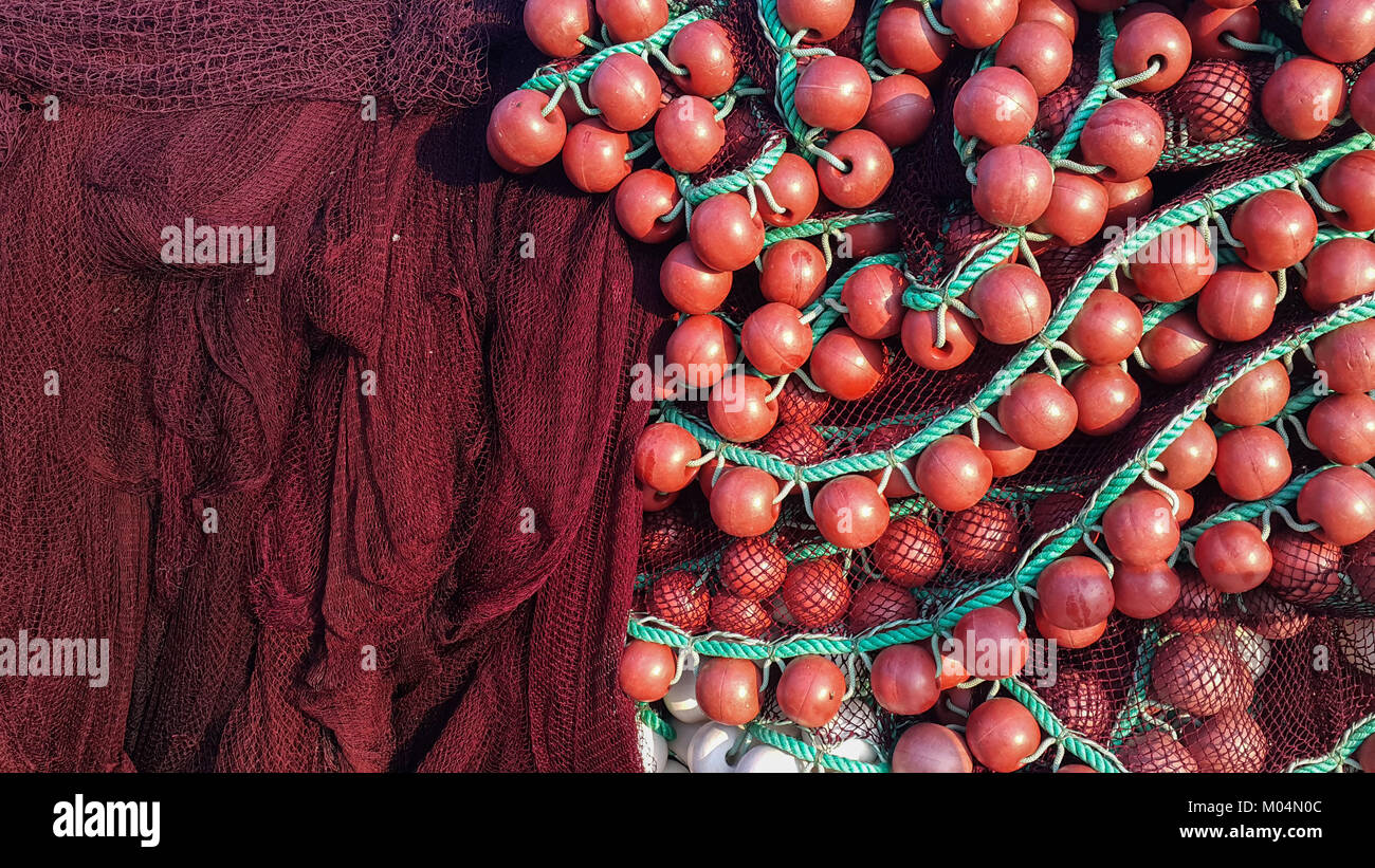 Several rope fishing nets hang on a ship board and ready for use Stock ...