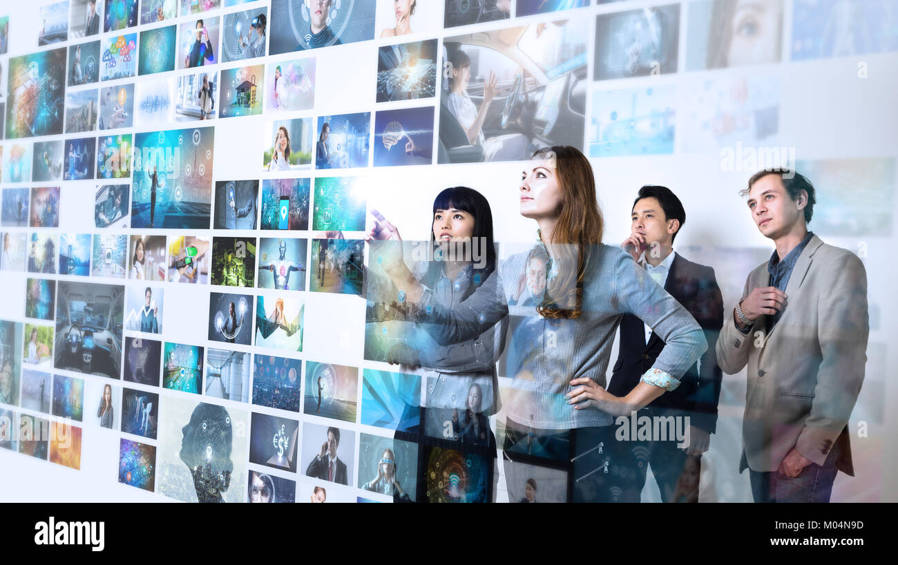 Group of people watching at a lot of pictures. Internet of Things ...