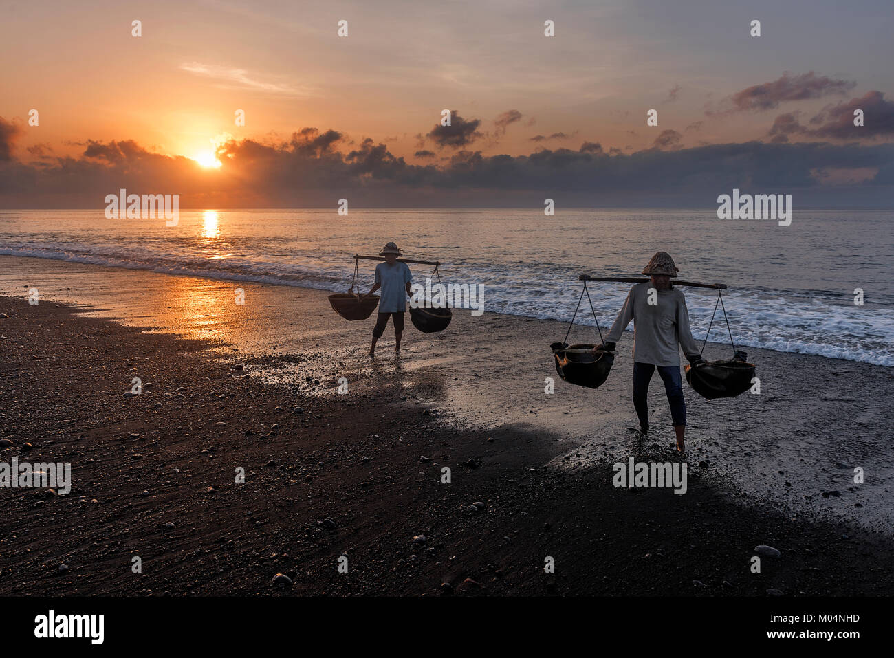 Indonesian salt farmer of Kusamba salt mining village in Bali ...