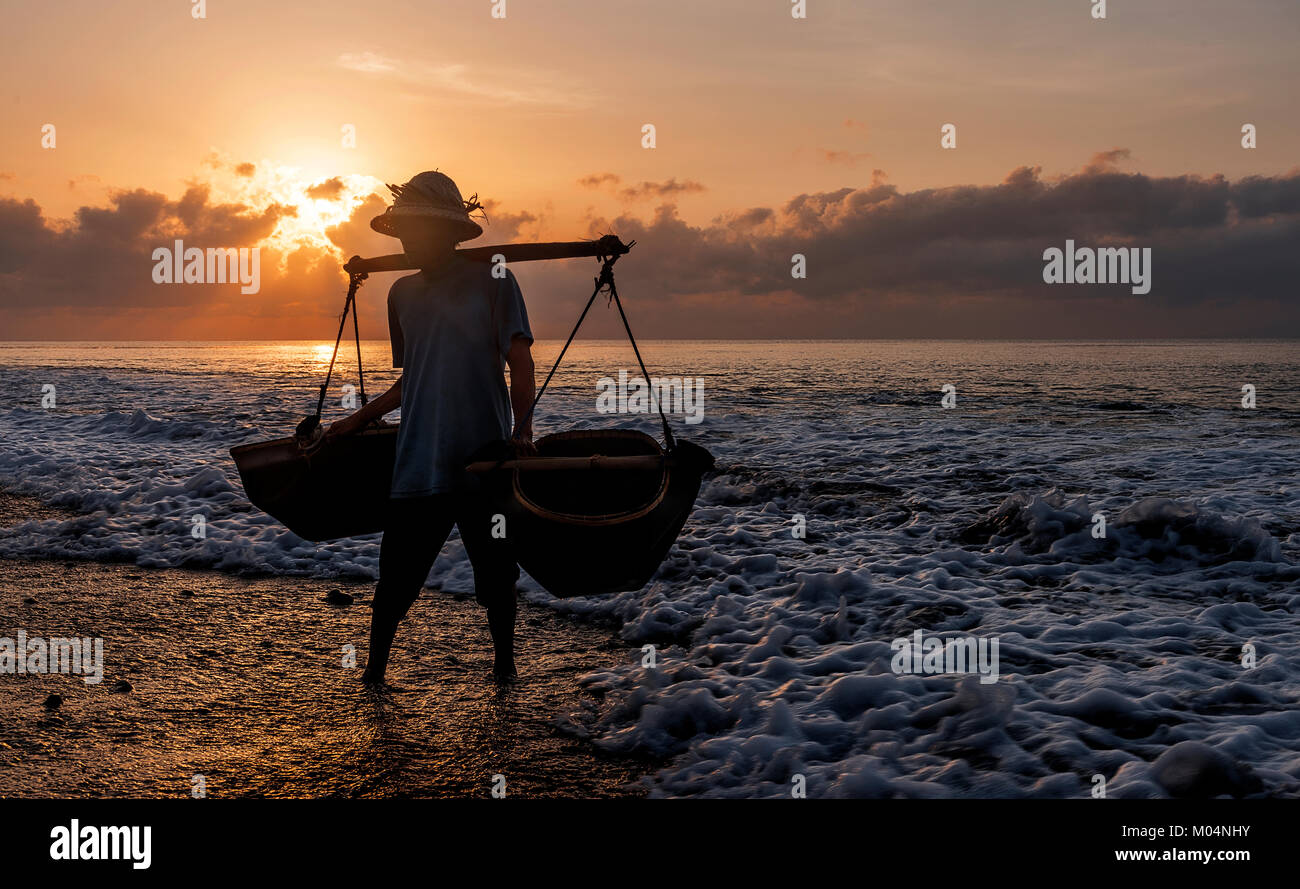 Indonesian salt farmer of Kusamba salt mining village in Bali ...