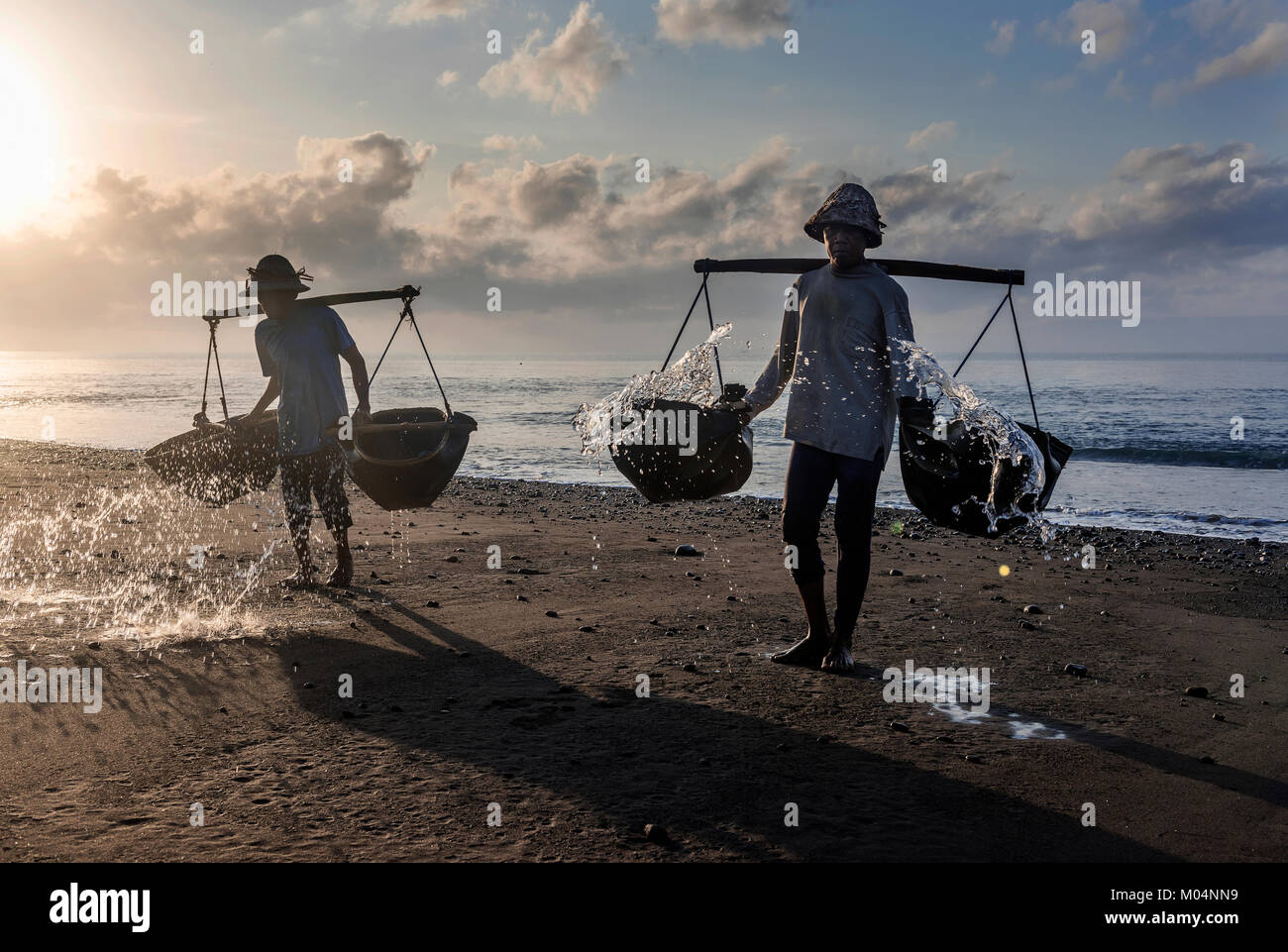 Indonesian salt farmer of Kusamba salt mining village in Bali ...