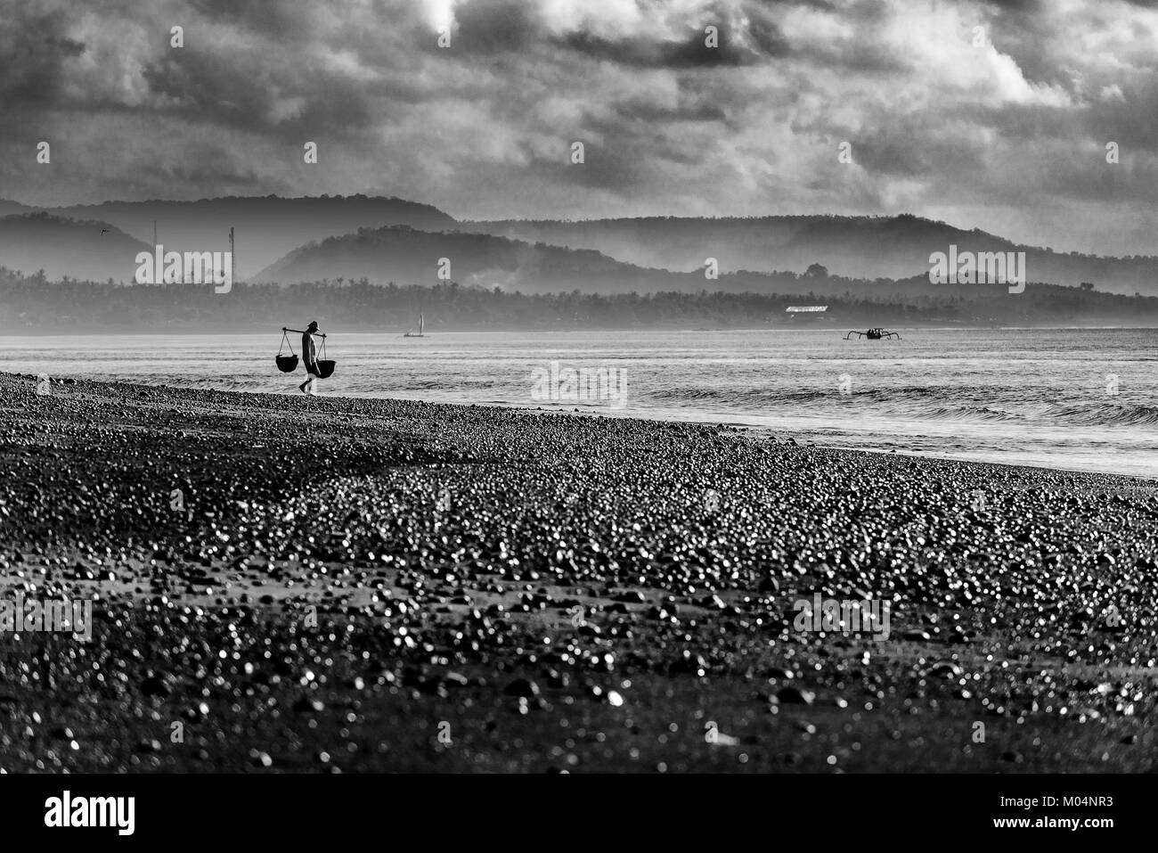 Indonesian salt farmer of Kusamba salt mining village in Bali ...