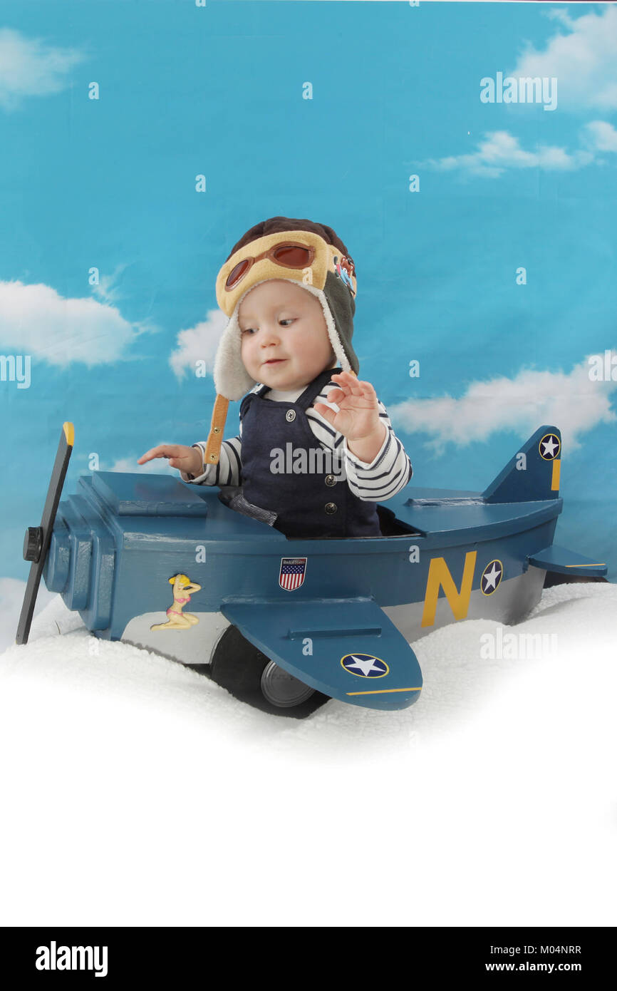 9 month old baby boy playing in toy fighter plain, child role play ...