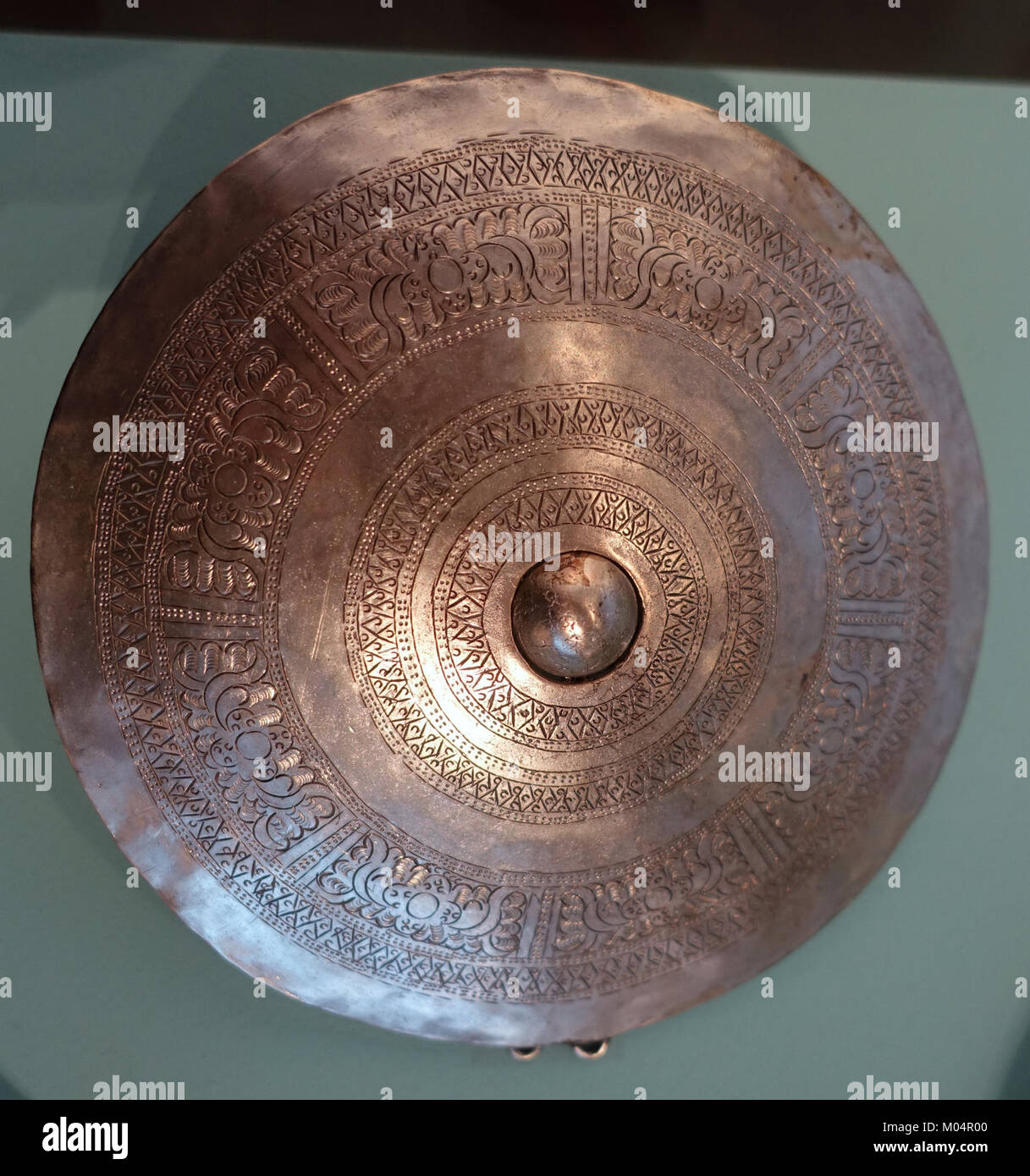 The image depicts a button disk from the Akha, Lahu, or Lisu people of ...
