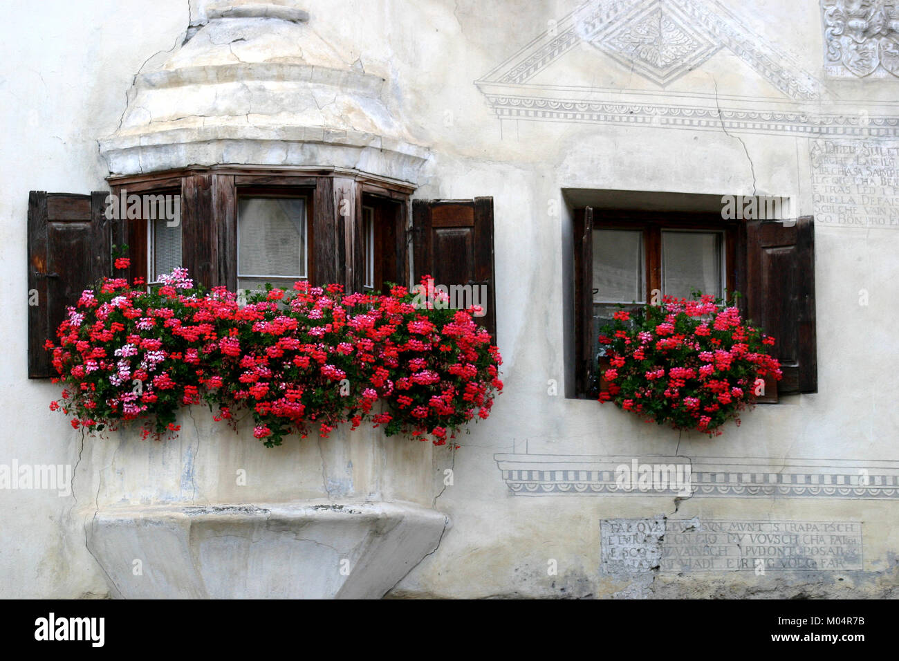 Beautifully ornamented windows in the village of Guarda, Switzerland ...