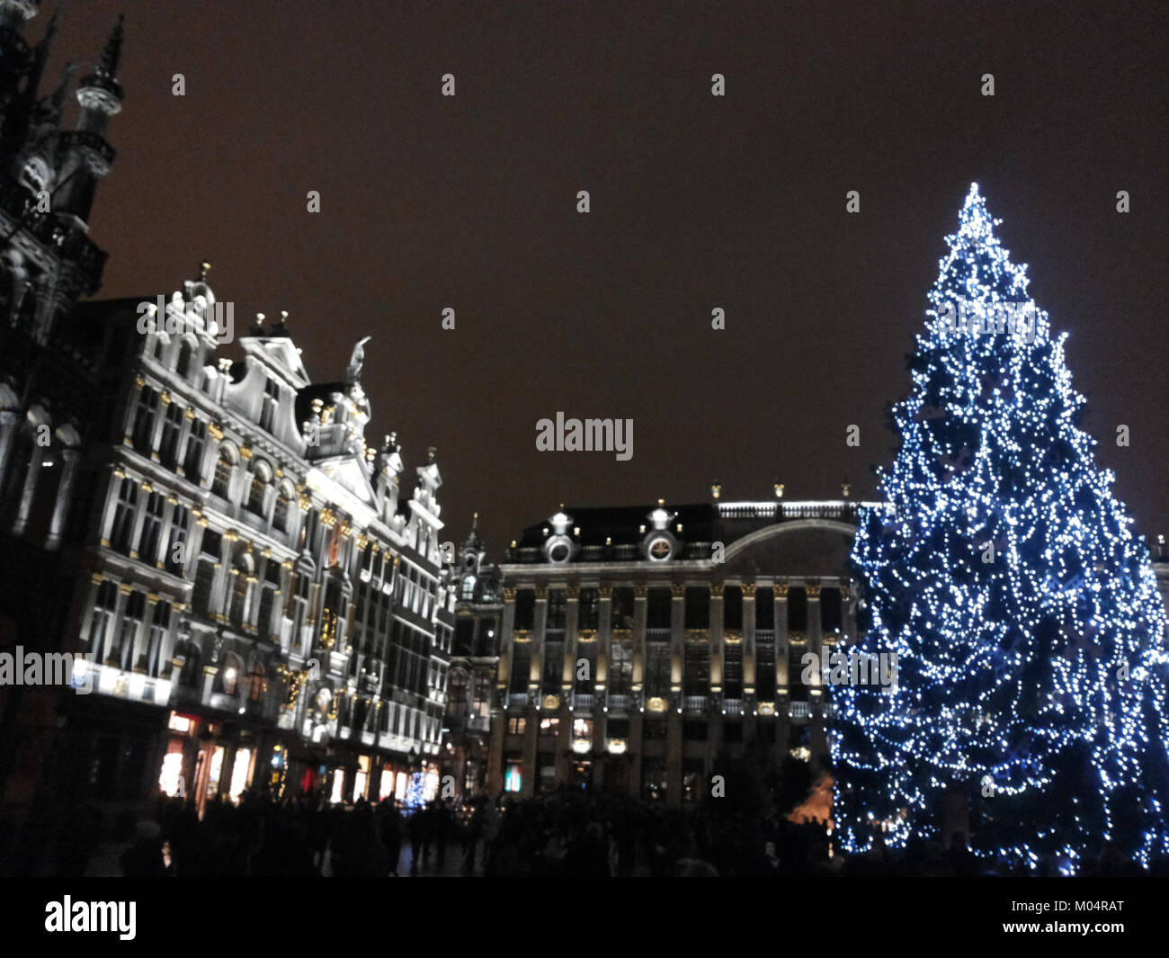 The Grand Place in Brussels, illuminated during the evening, showcases ...