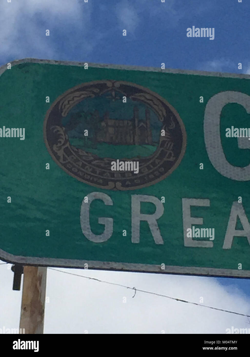 A street sign featuring the seal of Cambridge, Massachusetts ...