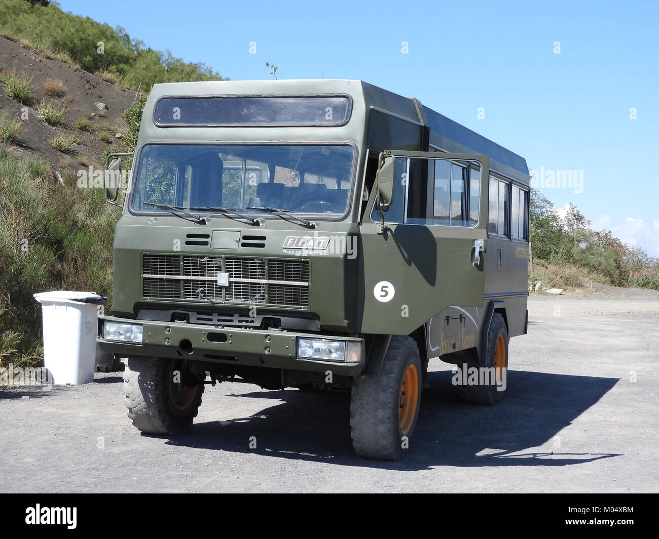 This image captures a bus journey to the summit of Mount Vesuvius, an ...