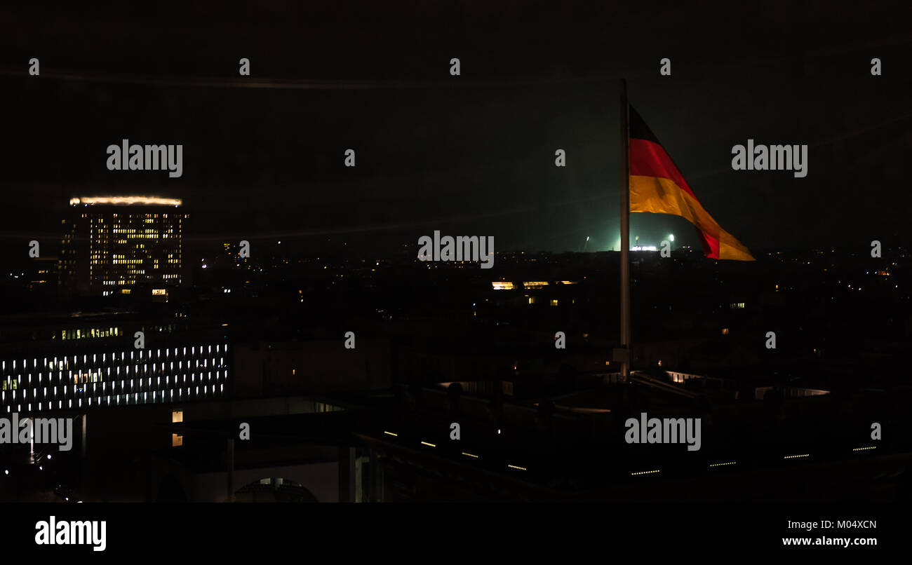 German Flag on Reichstag, Berlin, night view with city lights in the ...