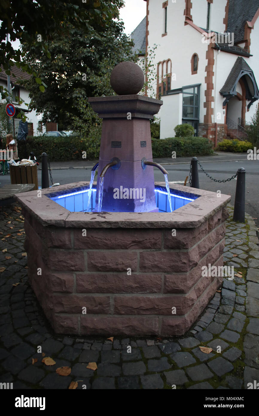 This image features a fountain (Brunnen) with lighting, highlighting ...